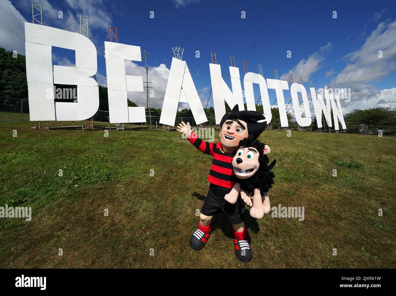 Dennis the Menace stands in front of a giant sign erected at Dundee Law ...