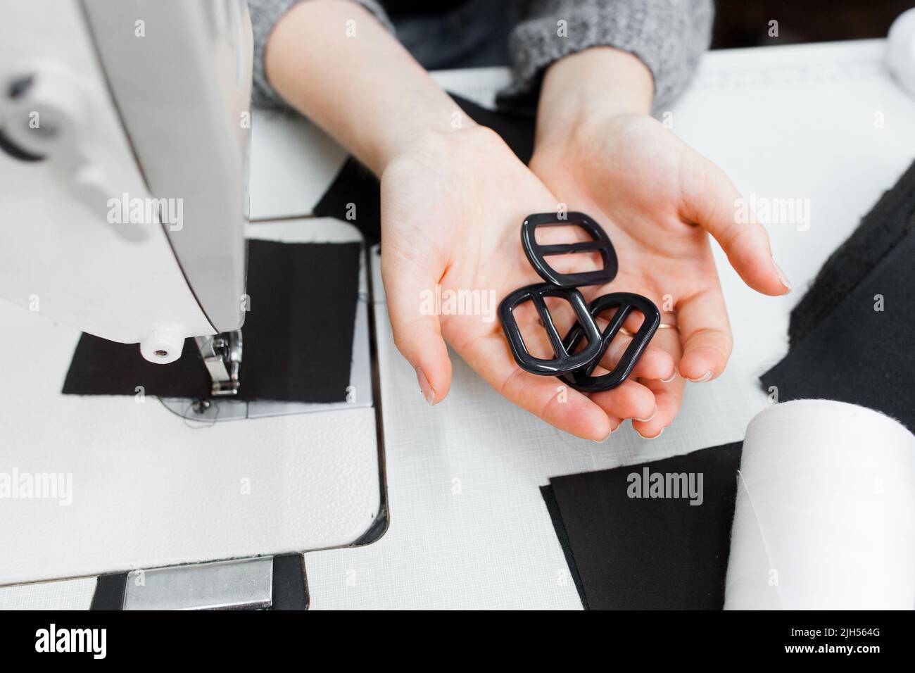 Designer hands with black buckles top view Stock Photo - Alamy