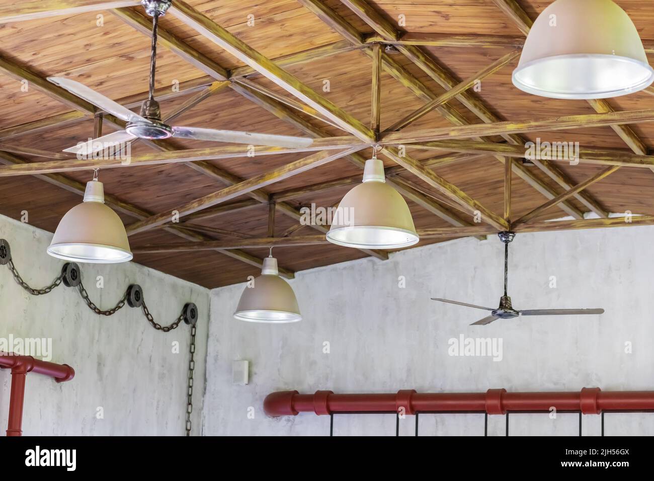 A fragment of room with gas pipes on the walls and identical lamps and ...