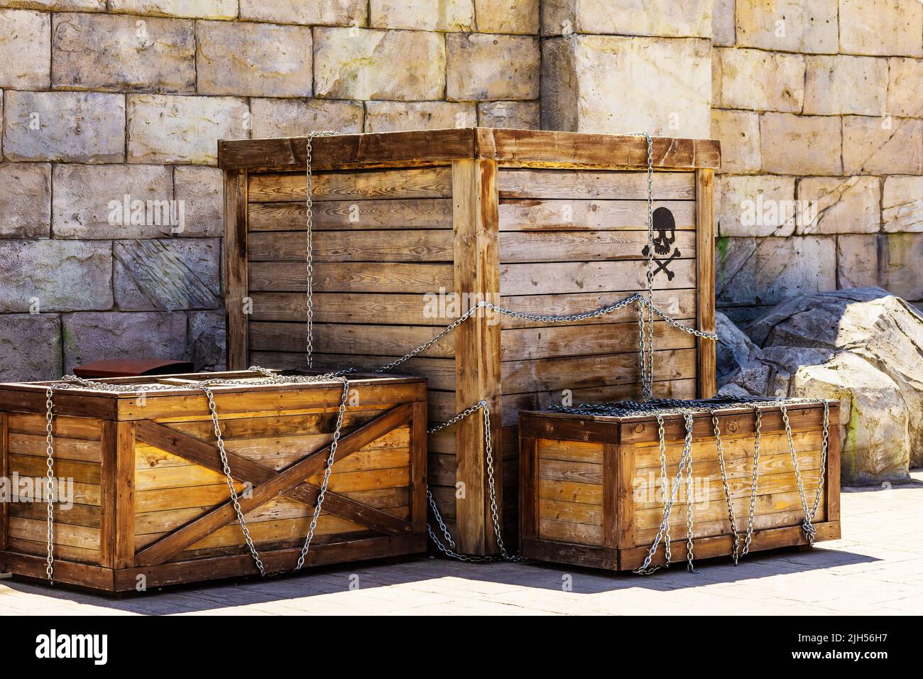 Wooden boxes depicting a skull and crossbones and hung with chains ...