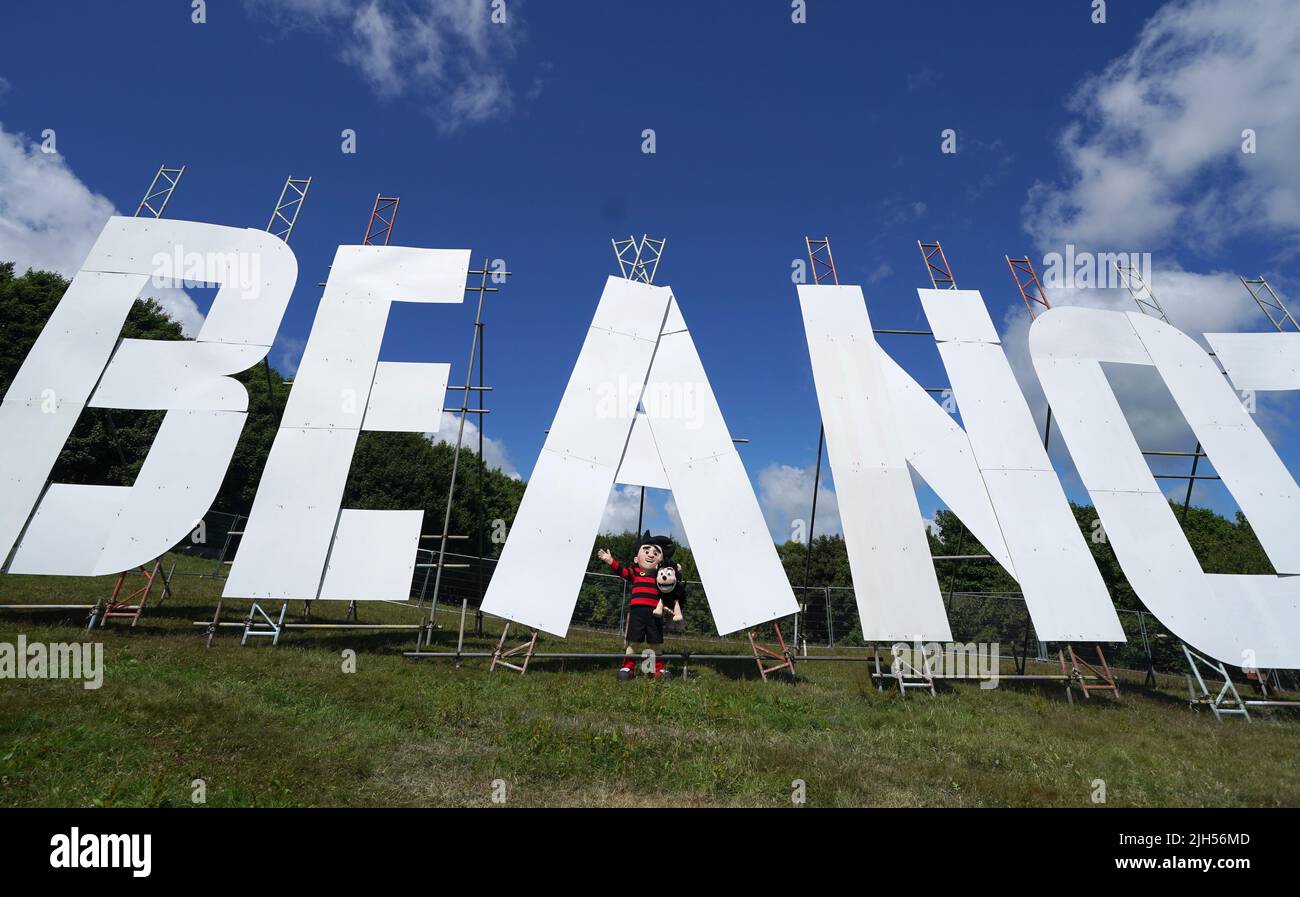 Dennis the Menace stands in front of a giant sign erected at Dundee Law ...