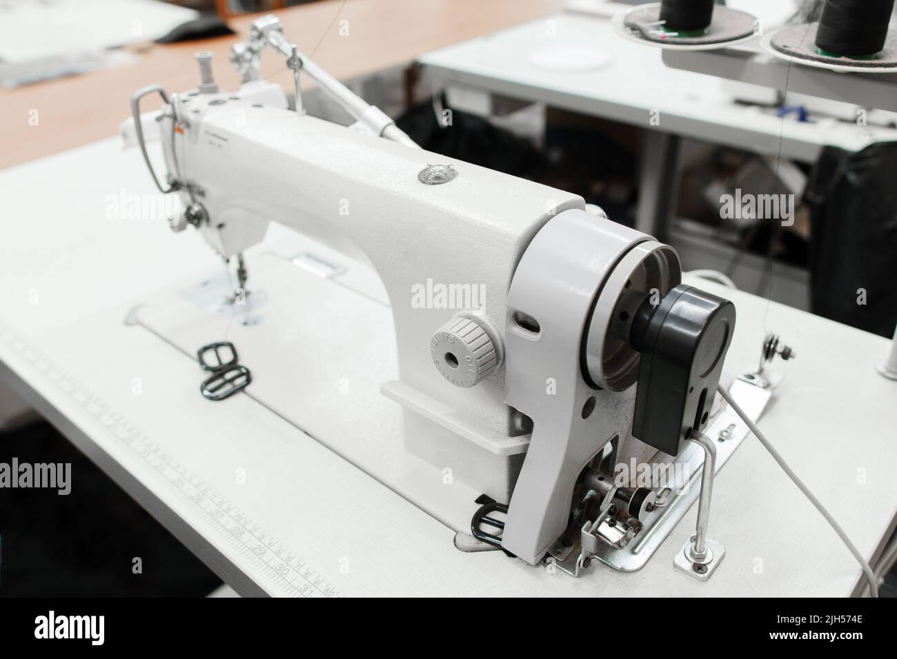 Close-up of sewing machine in workshop Stock Photo - Alamy