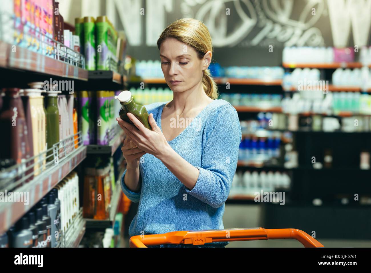 Woman checking label in grocery store hi-res stock photography and ...