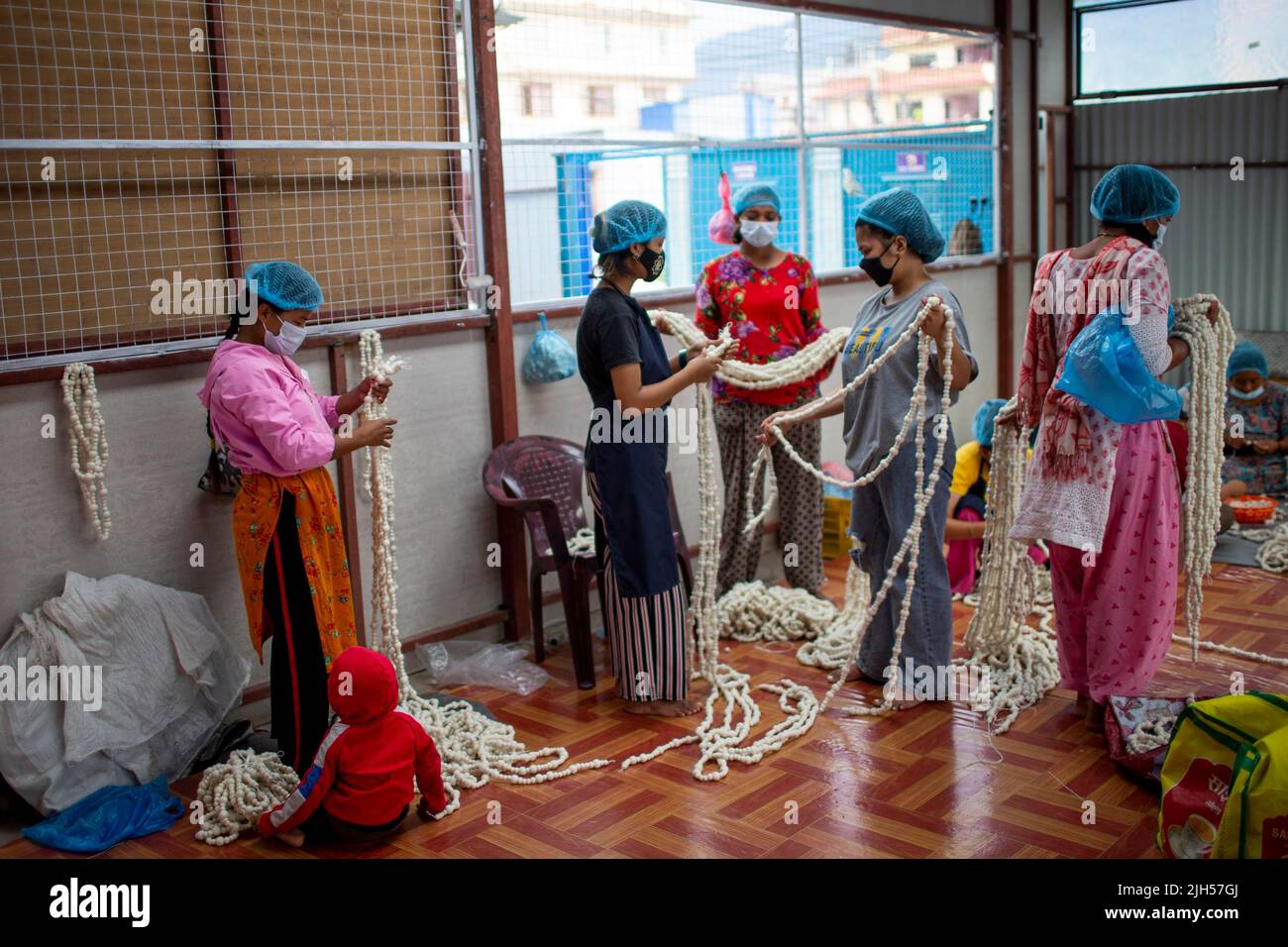 Kathmandu, Nepal. 15th July, 2022. Women make decorative woolen ...