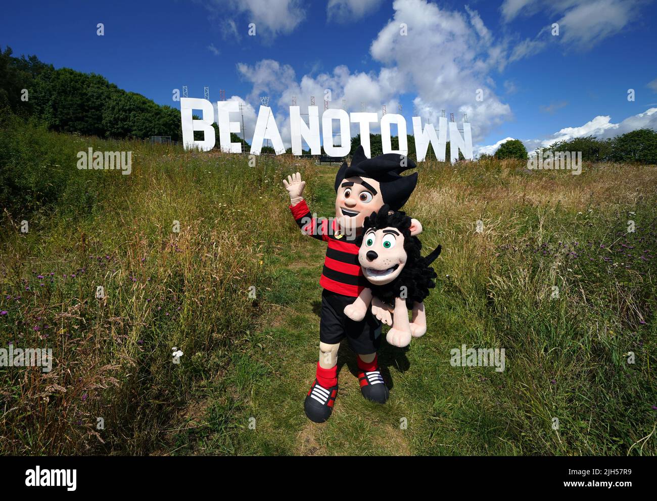 Dennis the Menace stands in front of a giant sign erected at Dundee Law ...