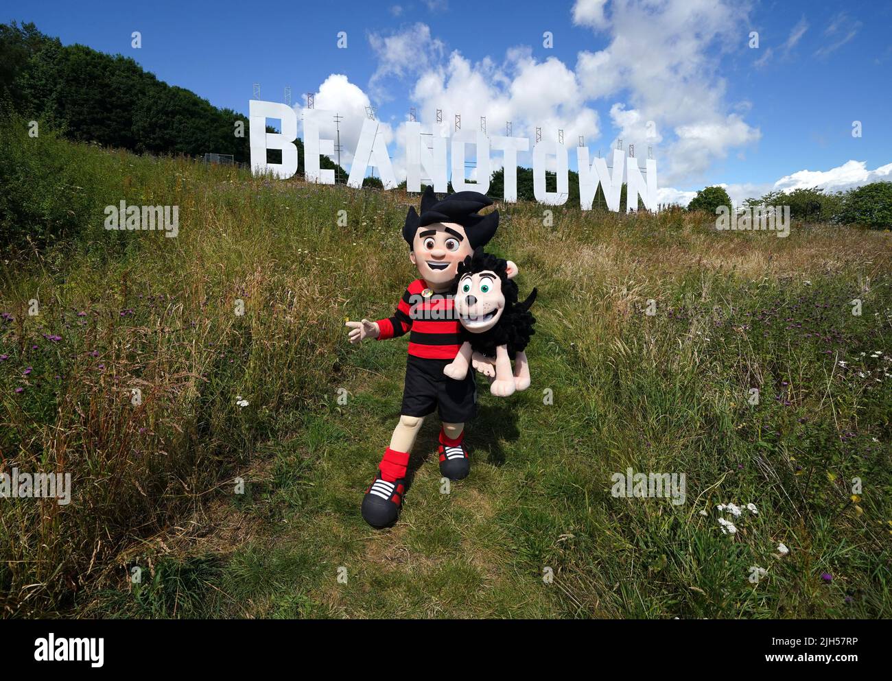 Dennis the Menace stands in front of a giant sign erected at Dundee Law ...