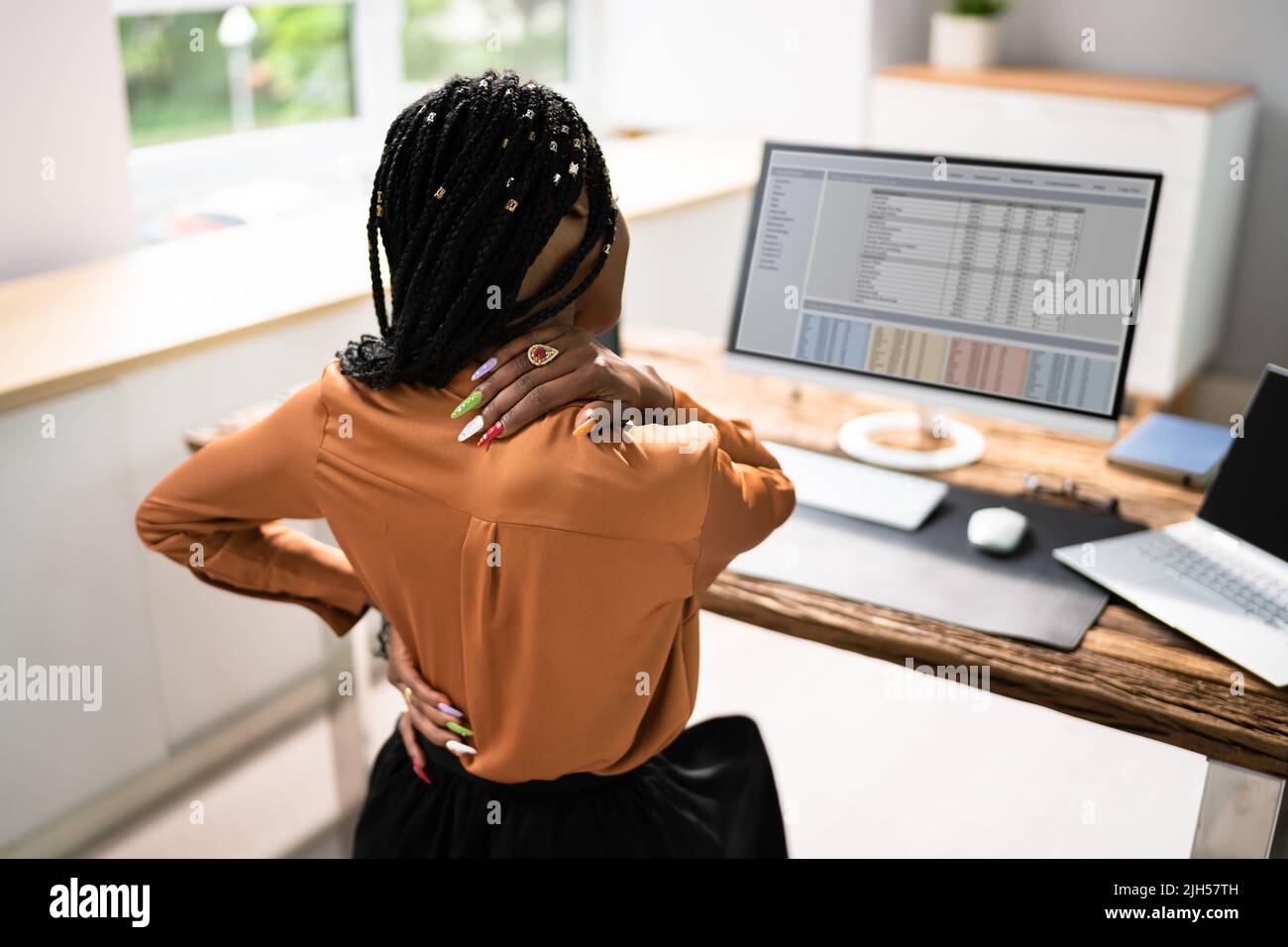 Back Pain Bad Posture Woman Sitting In Office Stock Photo - Alamy