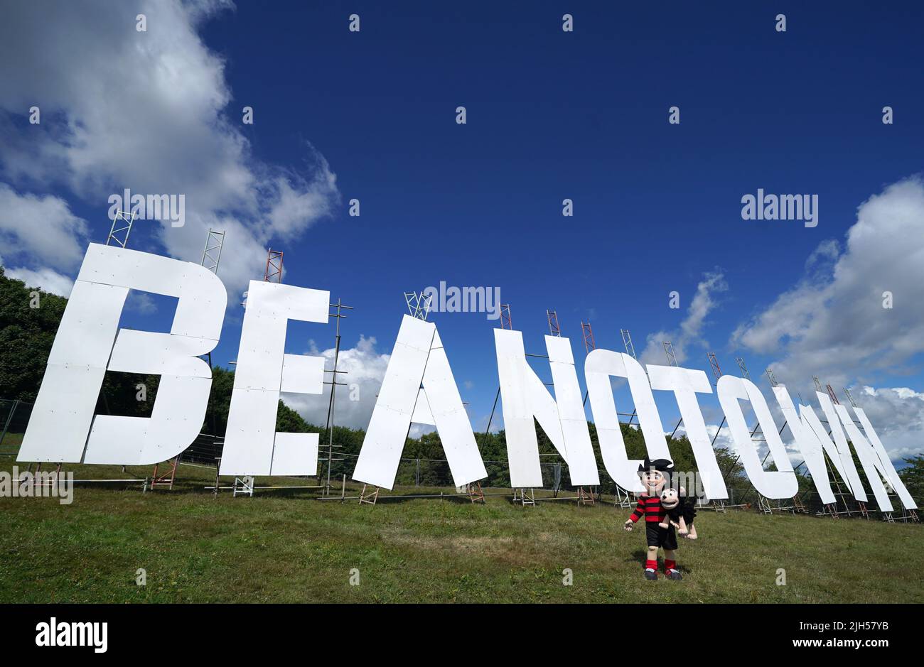 Dennis the Menace stands in front of a giant sign erected at Dundee Law ...