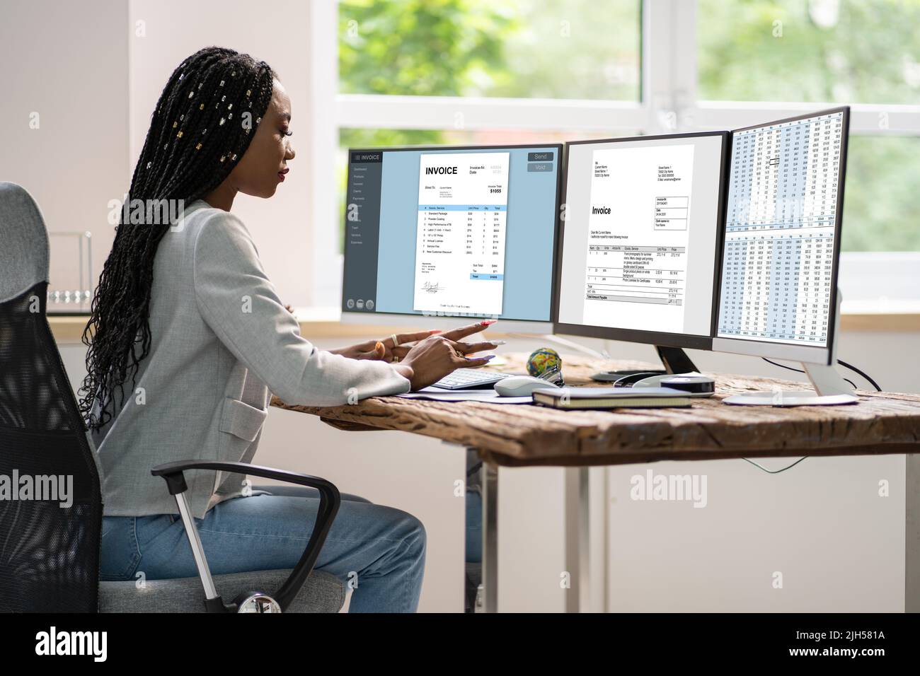 Spreadsheet And Electronic Invoice On Multiple Computer Screens Stock ...