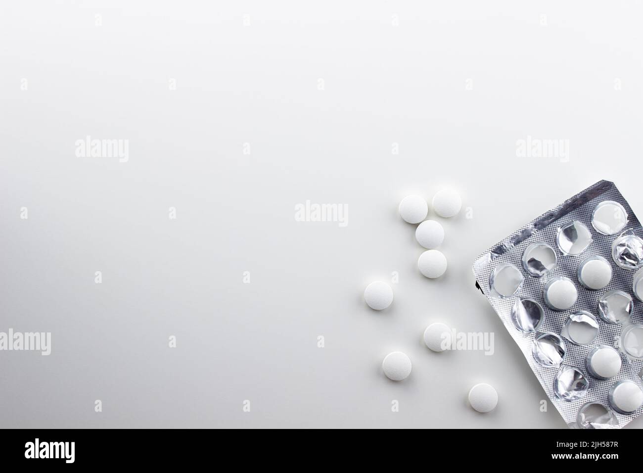 Three different blisters with white tablets of different form factors ...