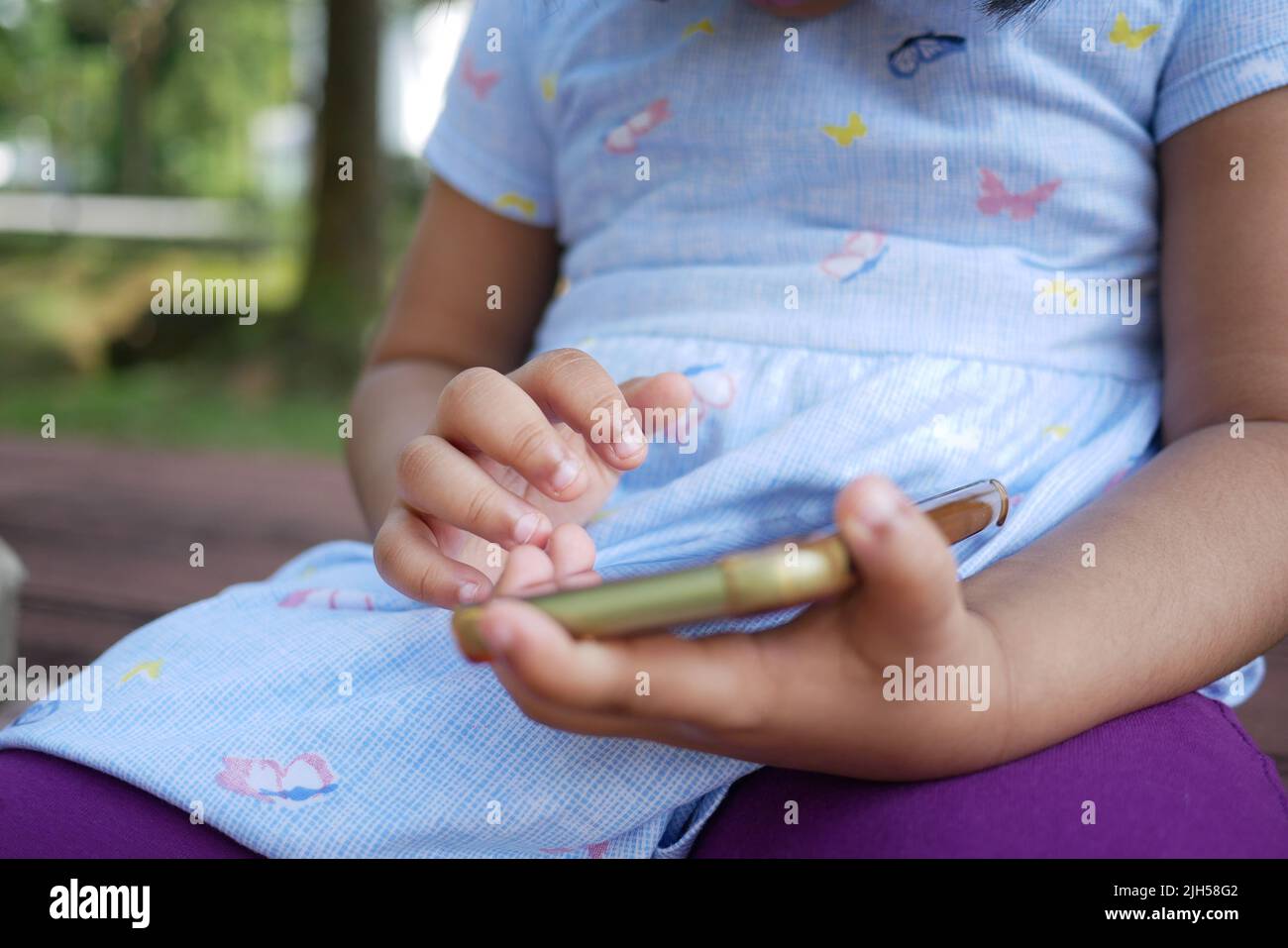 Child girl watching cartoon on smart phone Stock Photo - Alamy
