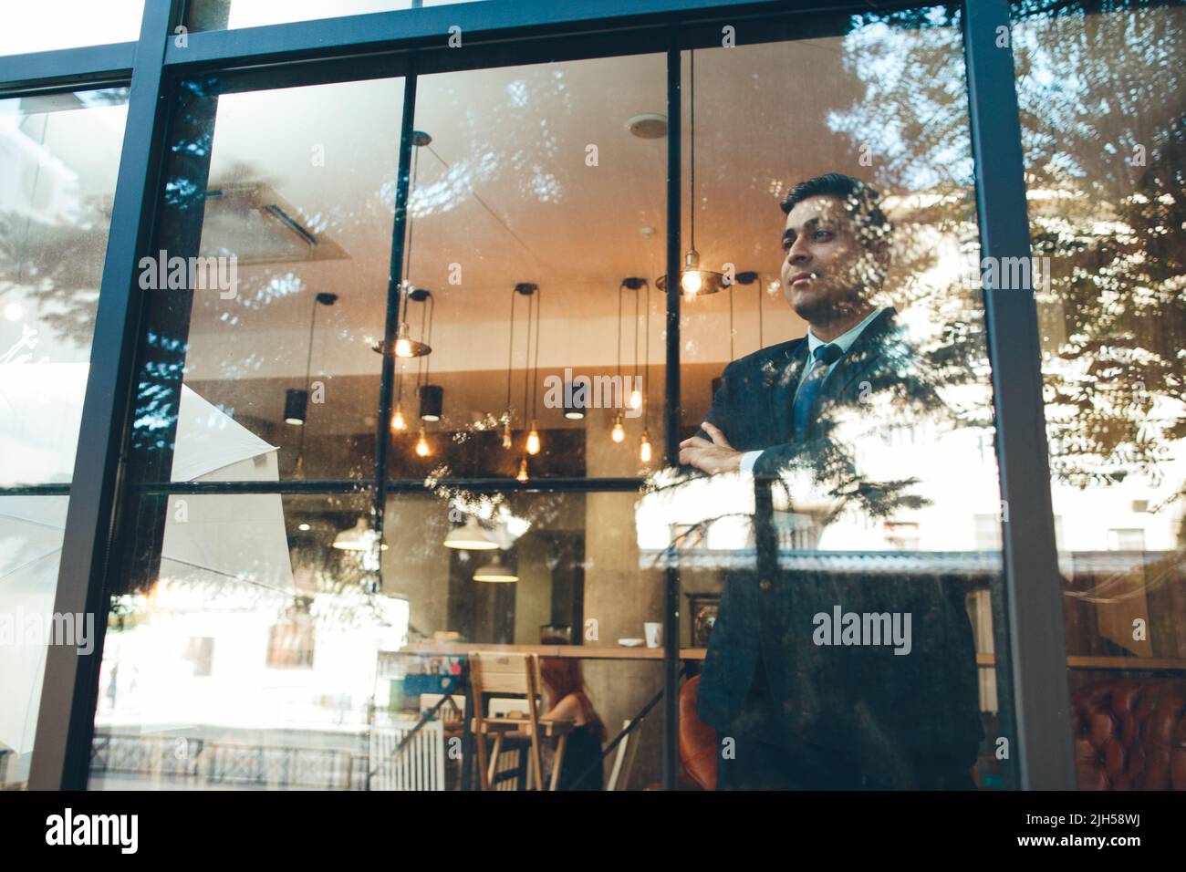 Successful ceo looking through window Stock Photo - Alamy