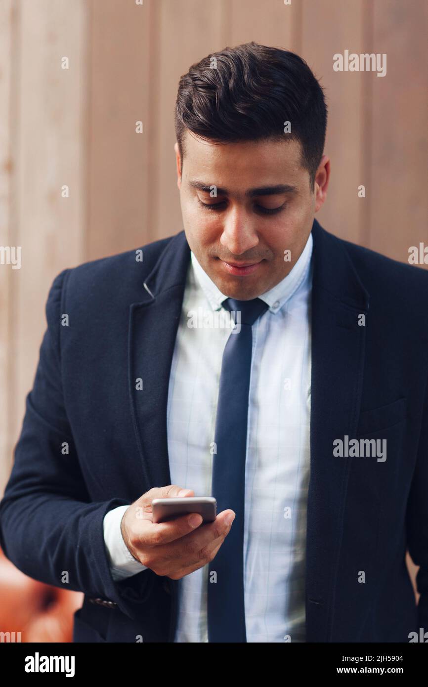Adult man holding smartphone in hands Stock Photo - Alamy