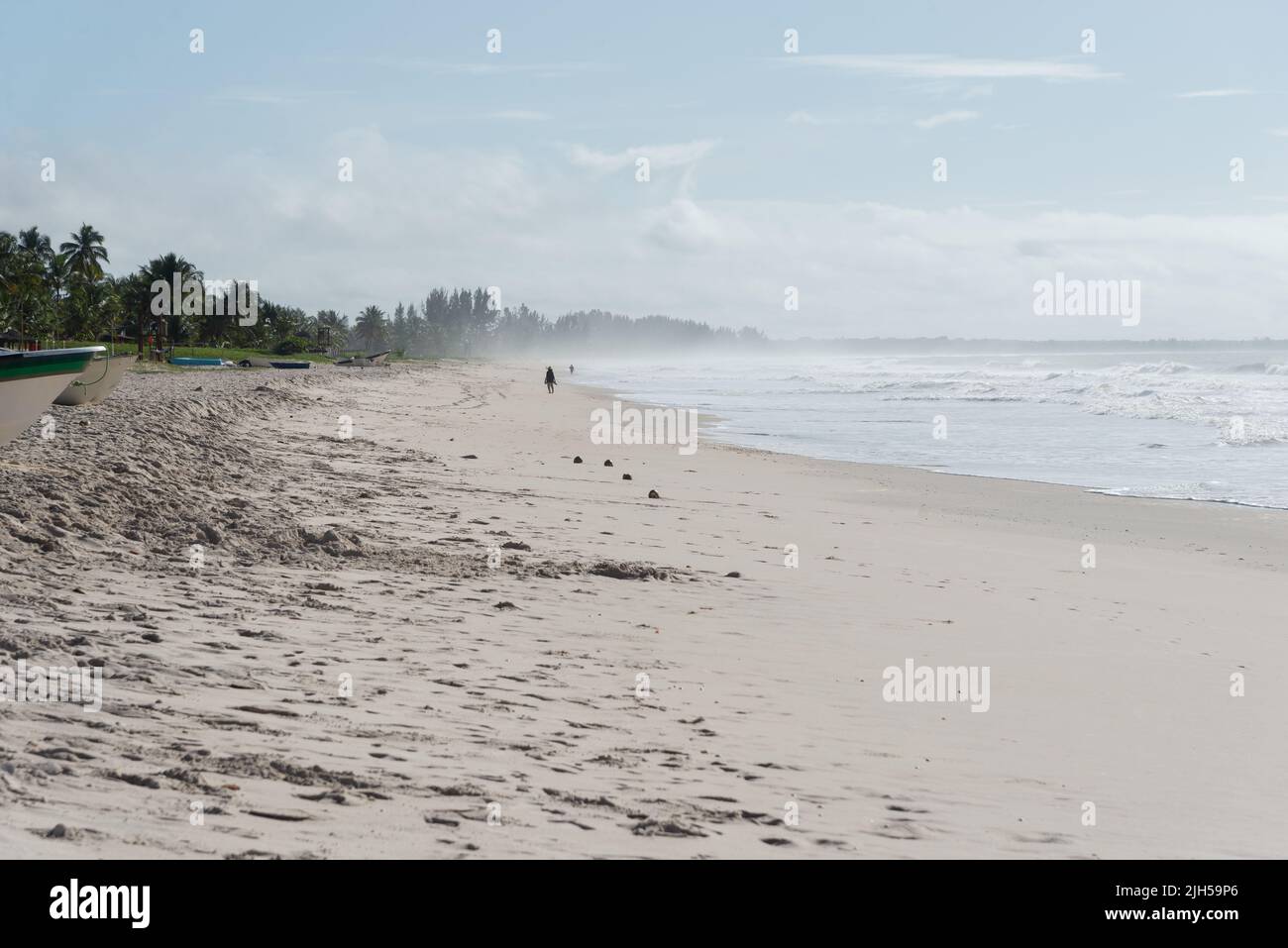 Clear and dense sand against blue sky with clouds and strong sun on ...