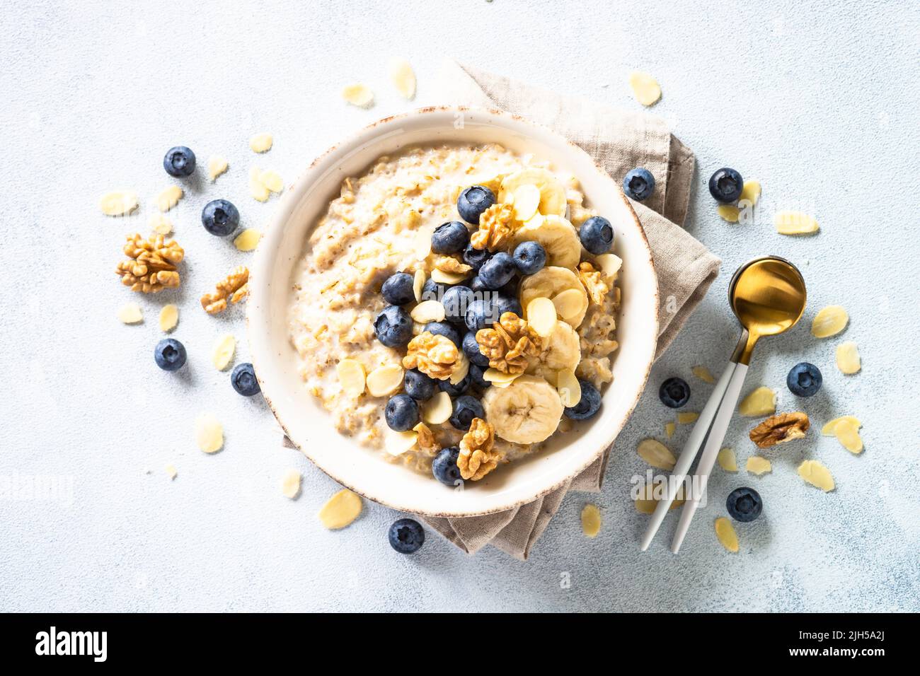 Oatmeal porrige in craft bowl at white background Stock Photo - Alamy