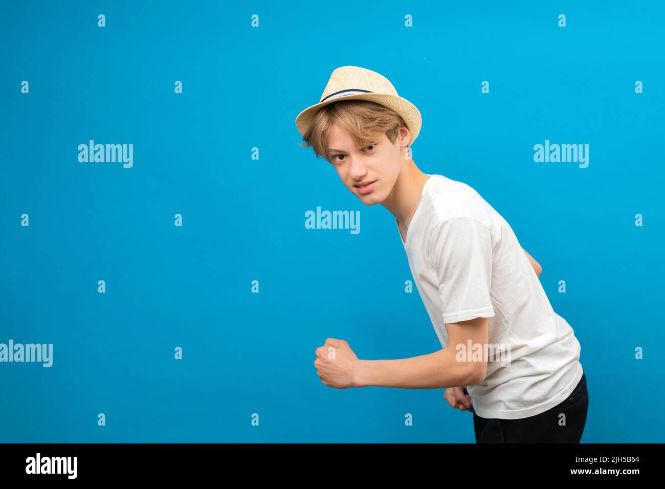 Hurry up. Fun energetic young handsome teen boy running in mid-air ...