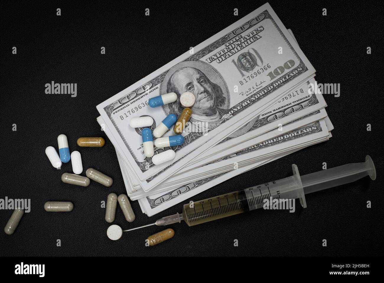 Drug medicine syringe and money banknote on the black background Stock ...