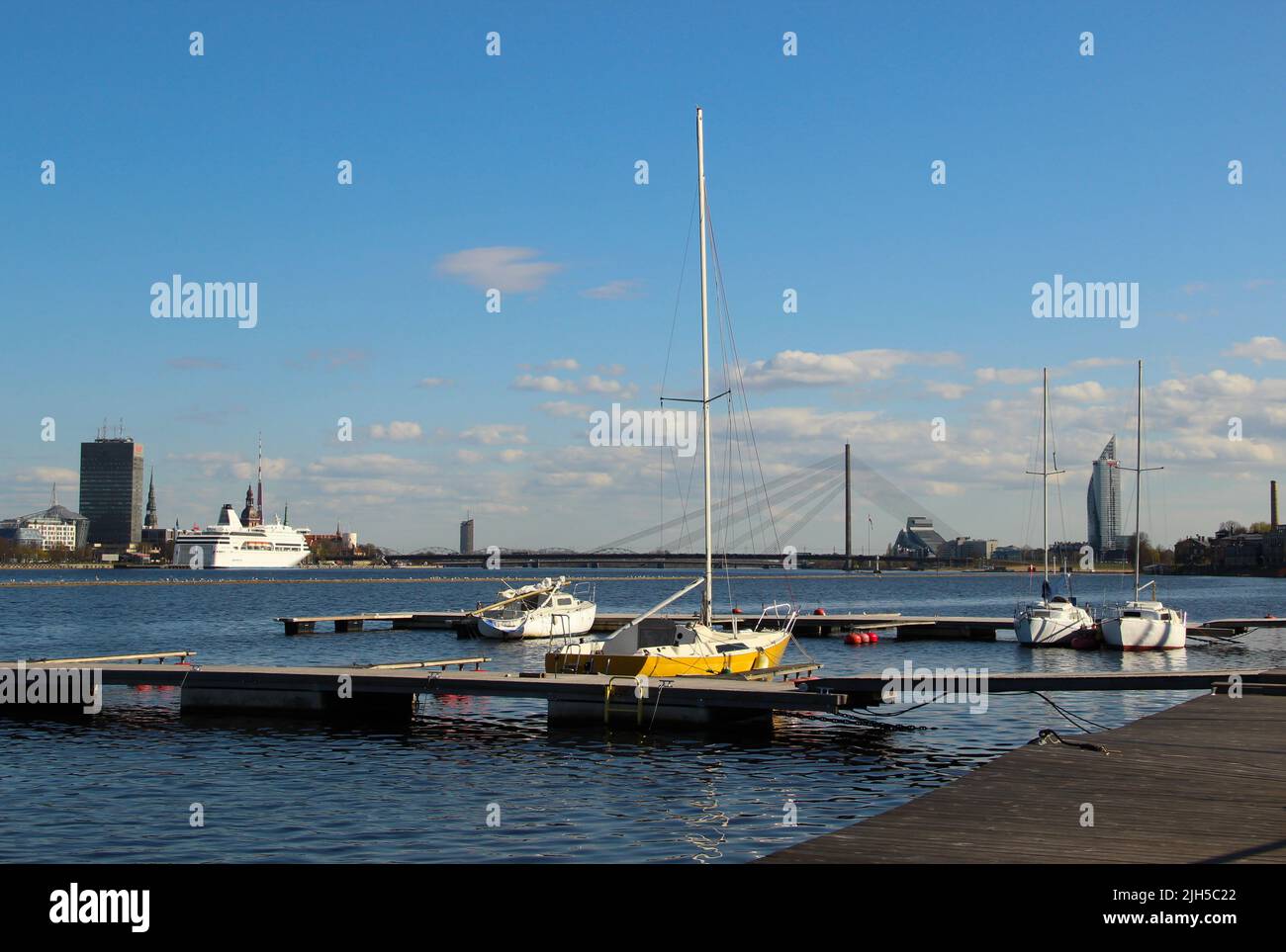 Dock with yachts on the Daugava river. City of Riga and sailboats in ...