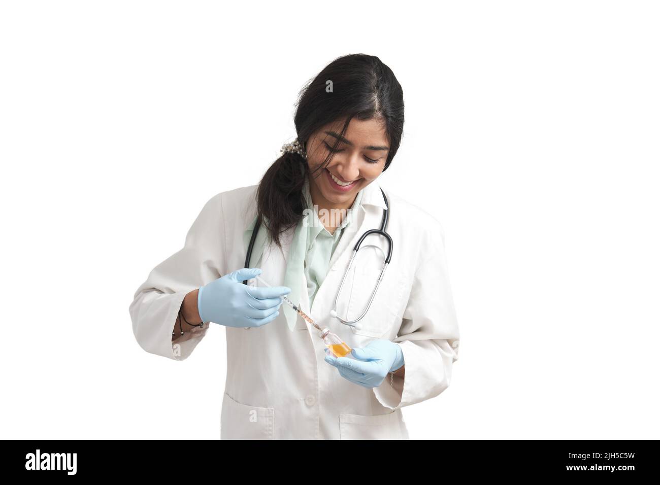 Young Venezuelan female doctor preparing a dose of a vaccine, isolated ...