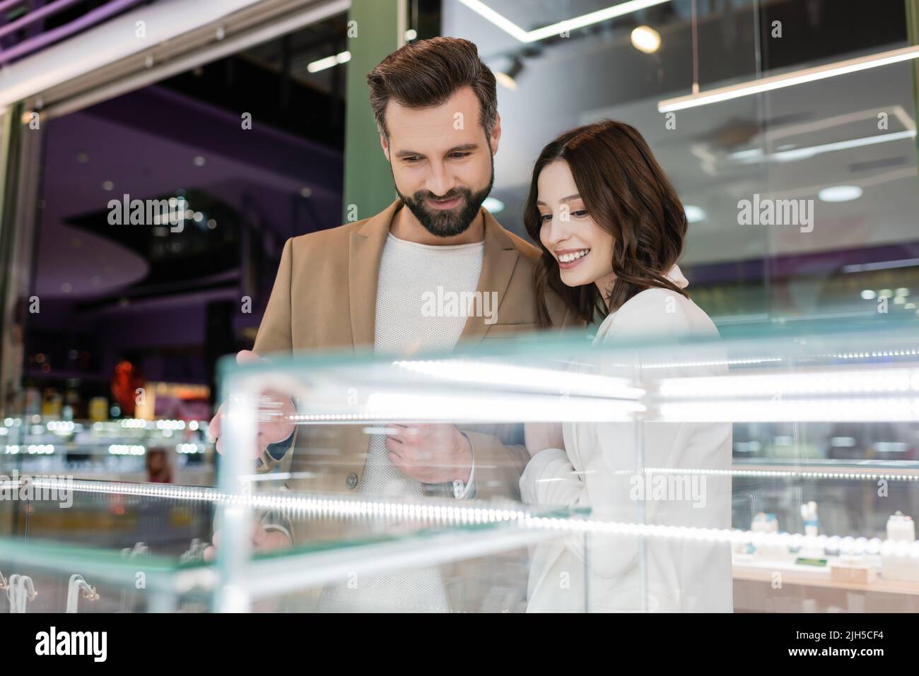 Couple looking at expensive jewellery hi-res stock photography and ...