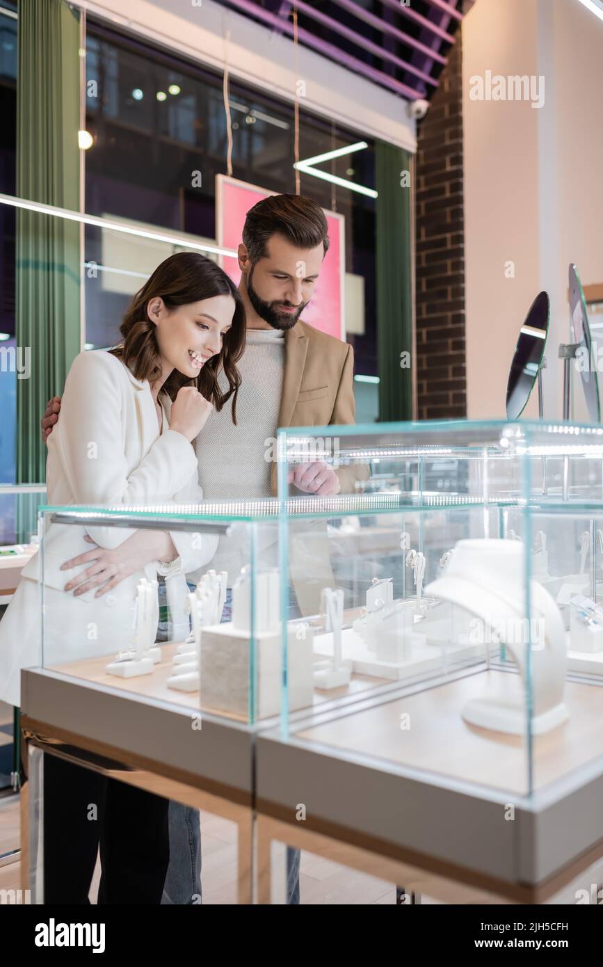 Couple looking at expensive jewellery hi-res stock photography and ...