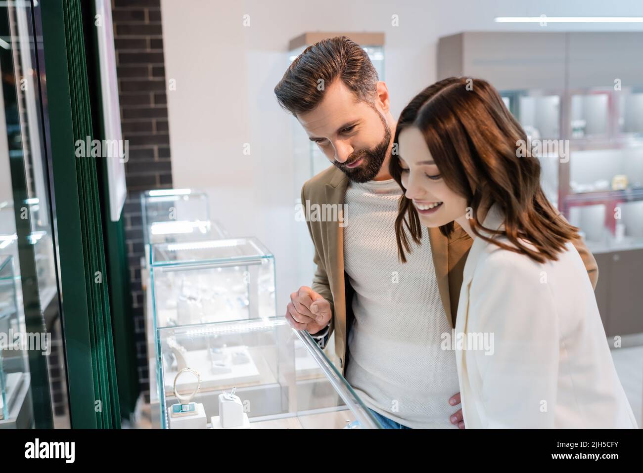 Couple looking at expensive jewellery hi-res stock photography and ...