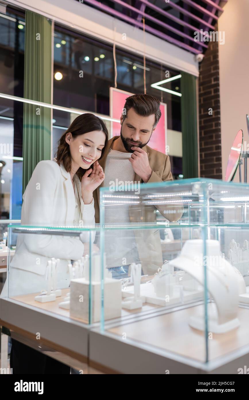 Couple looking at expensive jewellery hi-res stock photography and ...