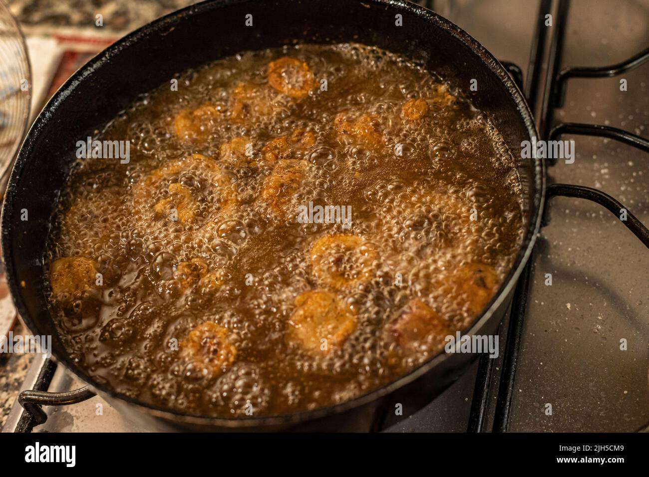 Fish frying in oil. Home made fish fried scene Stock Photo - Alamy
