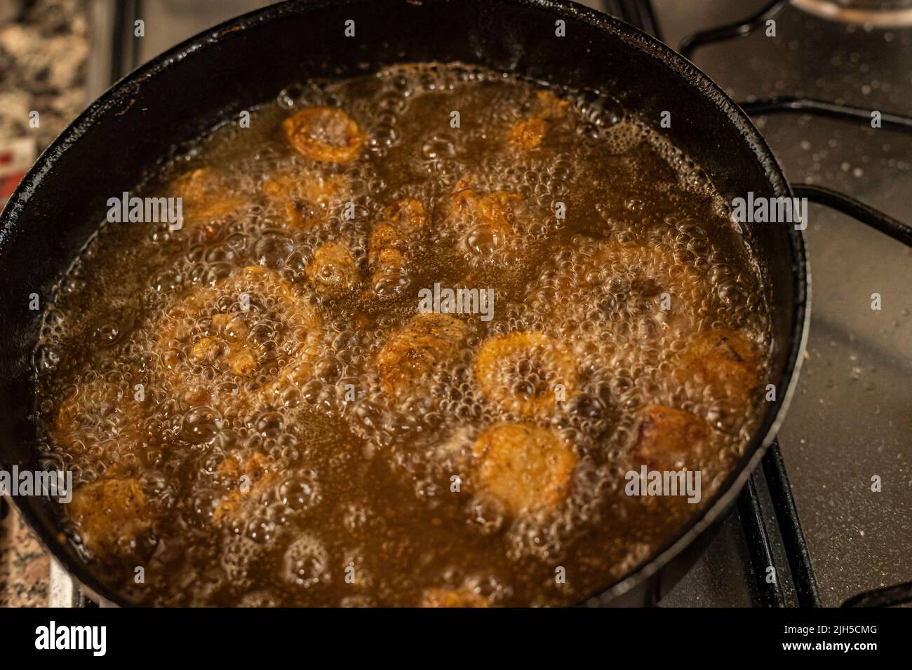 Fish frying in oil. Home made fish fried scene Stock Photo - Alamy
