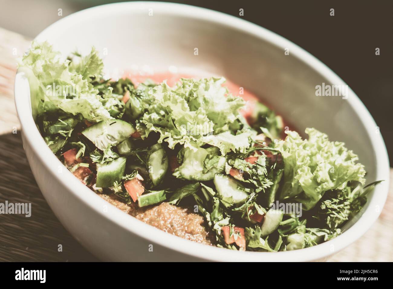 Ceramic white light bowl with mix green lettuce leaves, spinach leaf ...