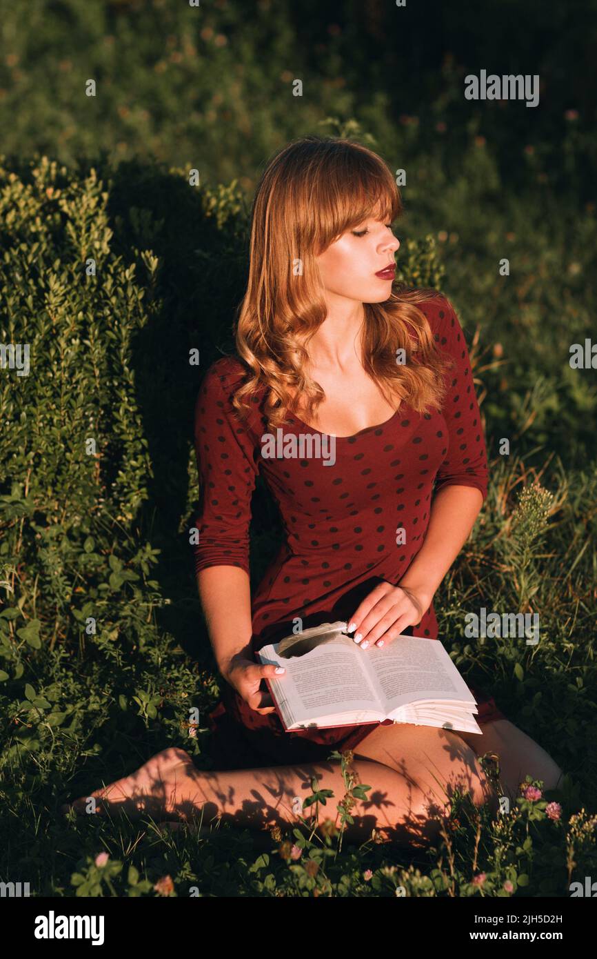 Beautiful woman reading book in nature Stock Photo - Alamy