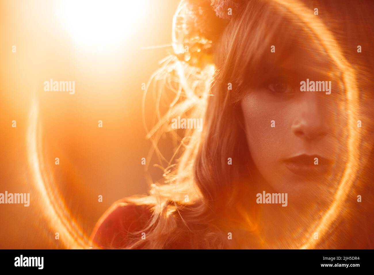 Portrait of beautiful woman, lens flare effect Stock Photo - Alamy