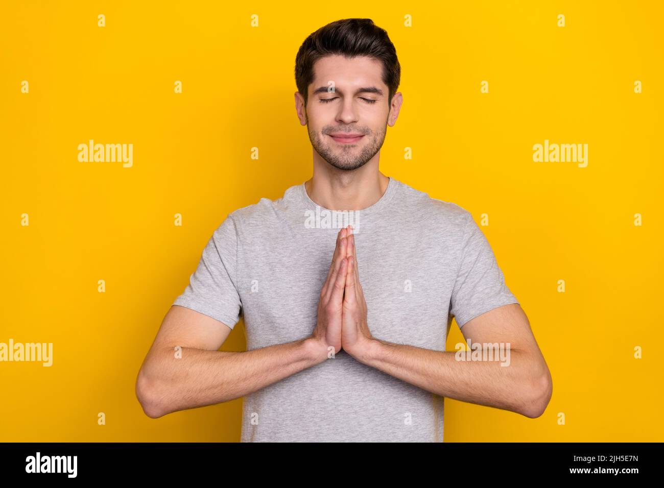 Photo of sleepy brunet millennial guy hold arms wear grey t-shirt ...
