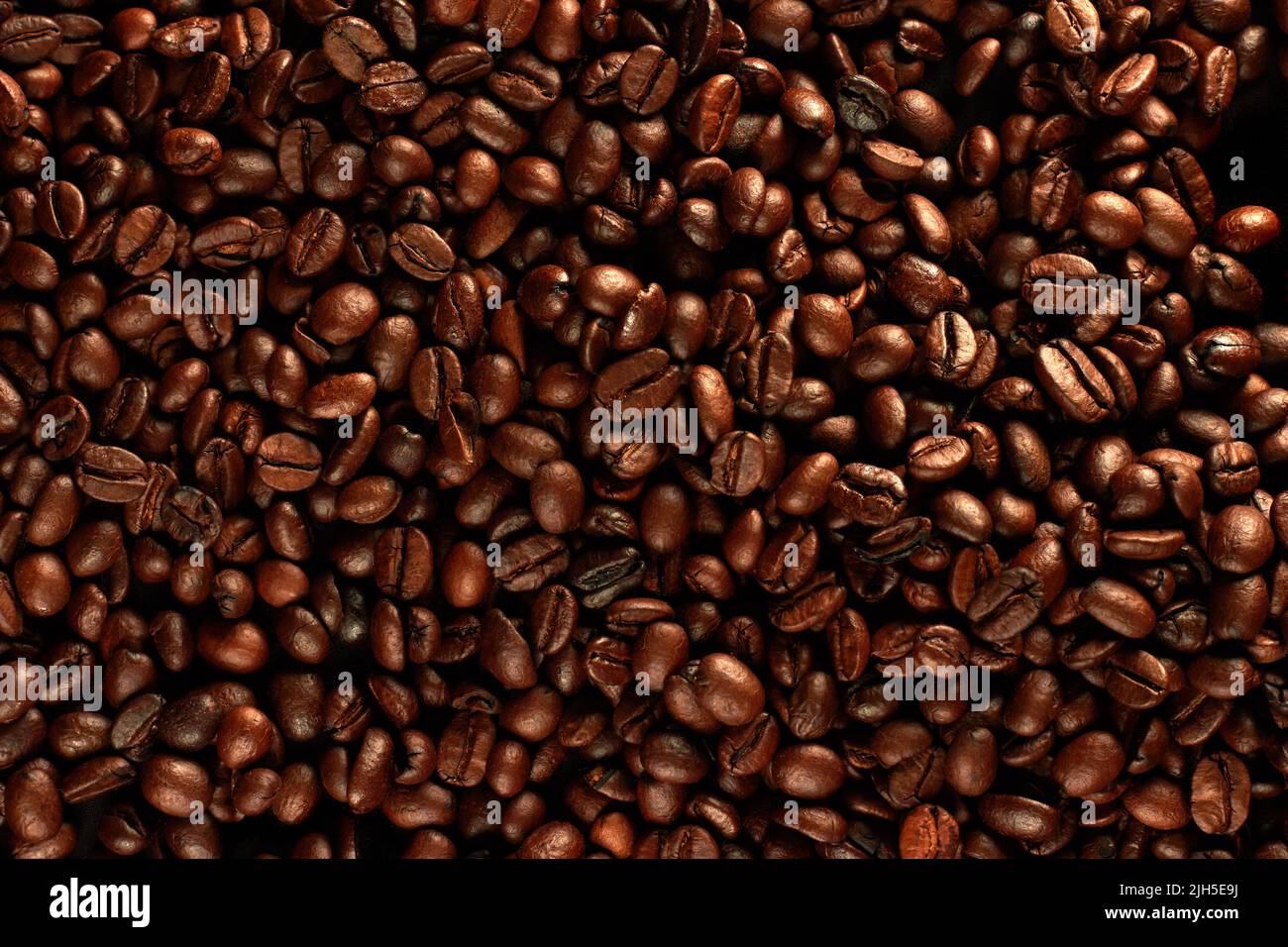 Top view of roasted coffee beans for background and texture. Piled of ...