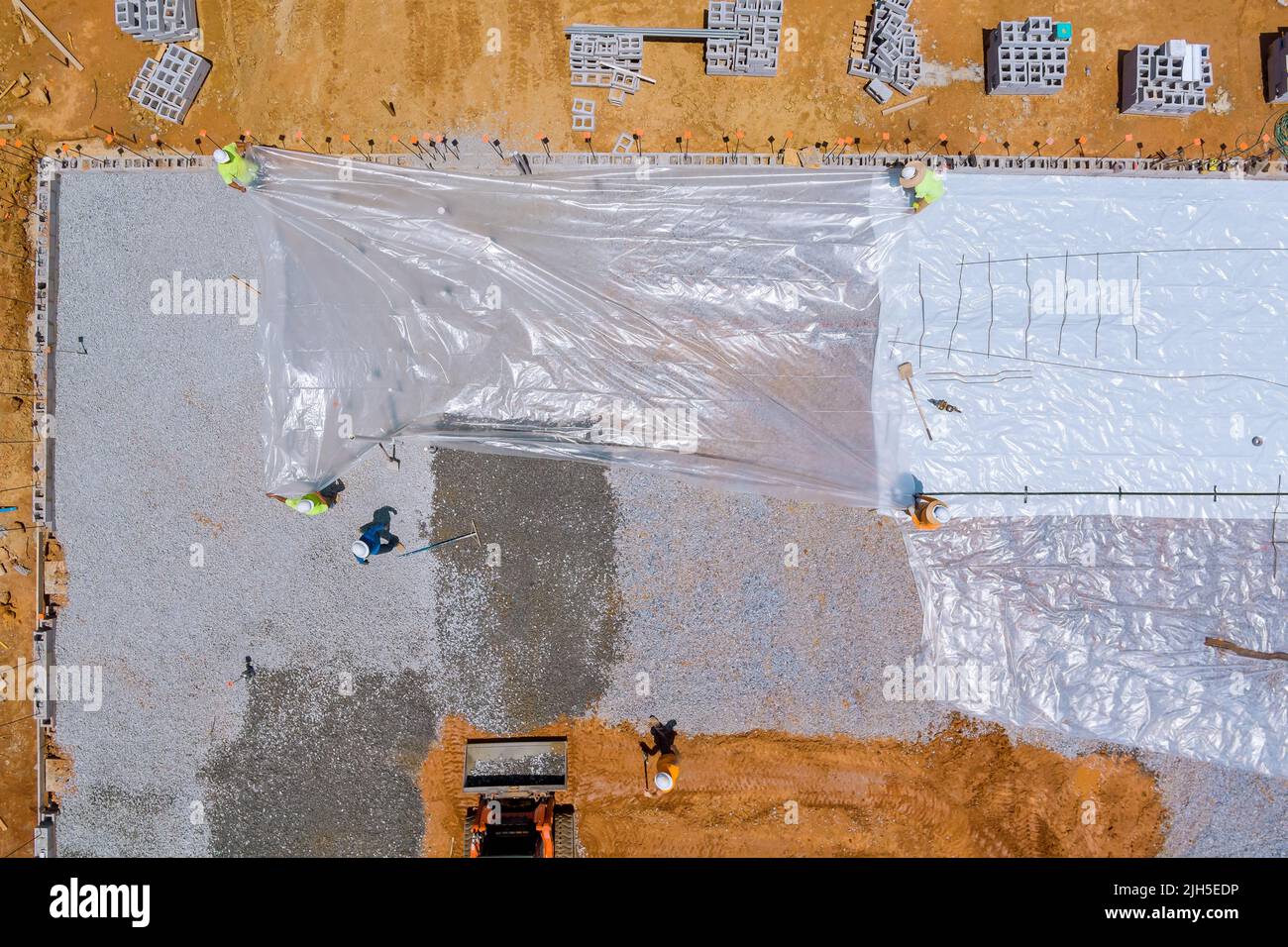 Work on leveling gravel on construction site with an excavator before ...