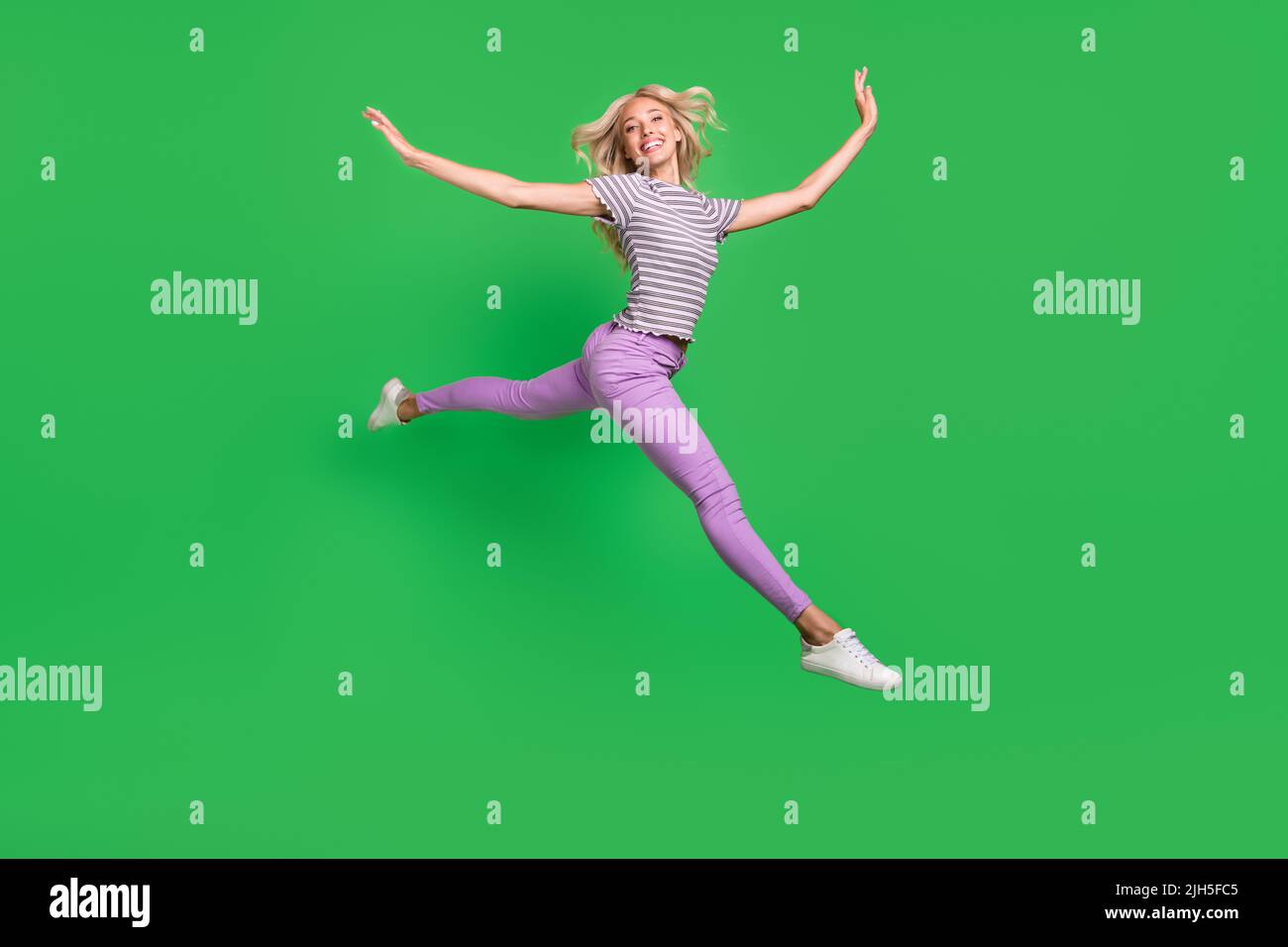 Full body portrait of sporty excited cheerful girl jumping rush hurry ...