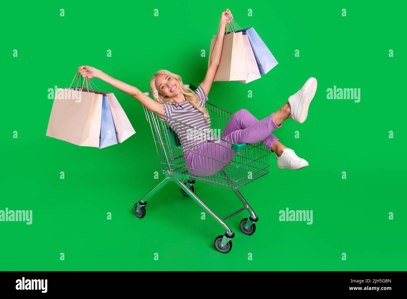 Full body portrait of cheerful positive lady sitting trolley hold raise ...