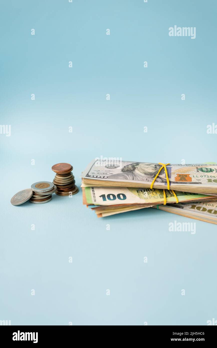 Multicurrency banknotes, euro coins, dollars on a blue background. The ...
