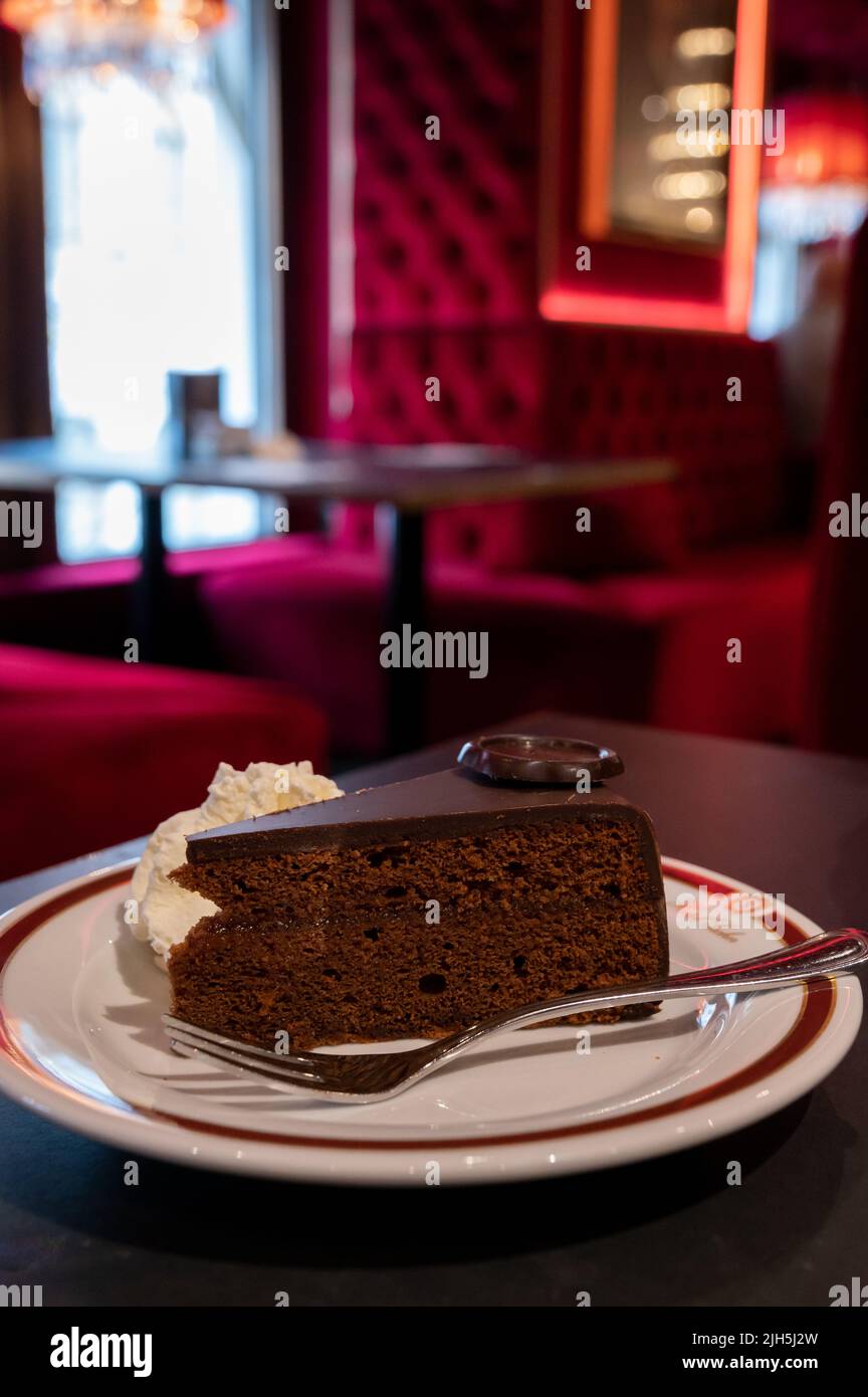Piece of famous Sachertorte chocolate cake with apricot jam of Austrian ...