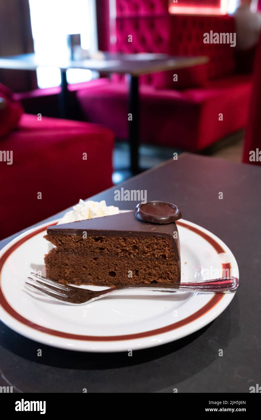 Piece of famous Sachertorte chocolate cake with apricot jam of Austrian ...
