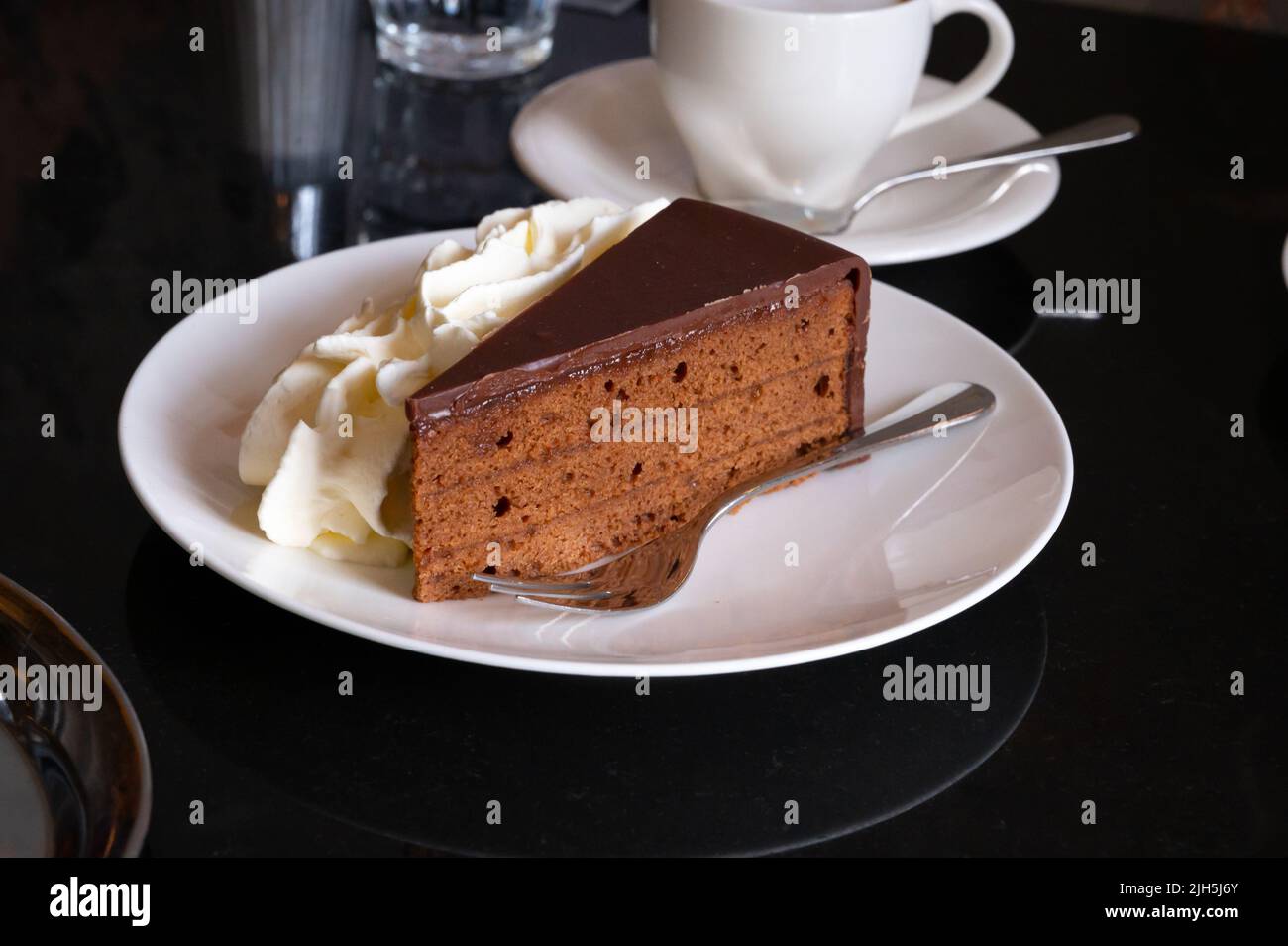 Piece of famous Sachertorte chocolate cake with apricot jam of Austrian ...