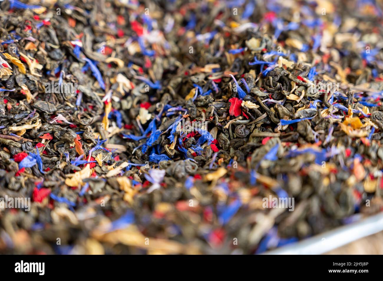 Blended black leaf dry tea with aromatic flowers, spices in tea shop in ...