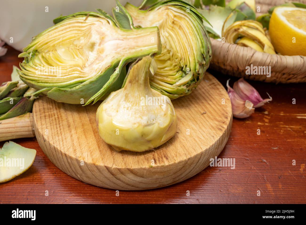 Cooking of green heads of artichokes plants, how to peel raw artichoke ...