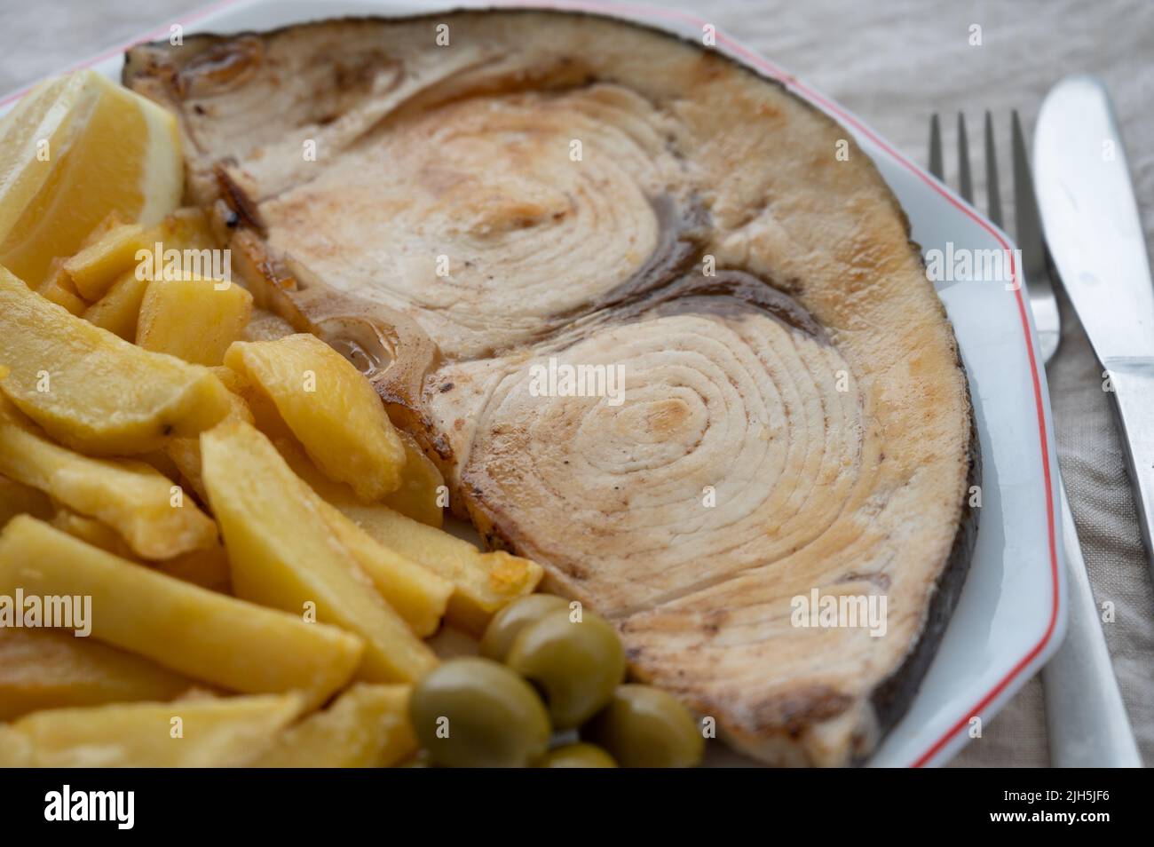 Seafood dish, grilled steak from swordfish or spada served with french ...