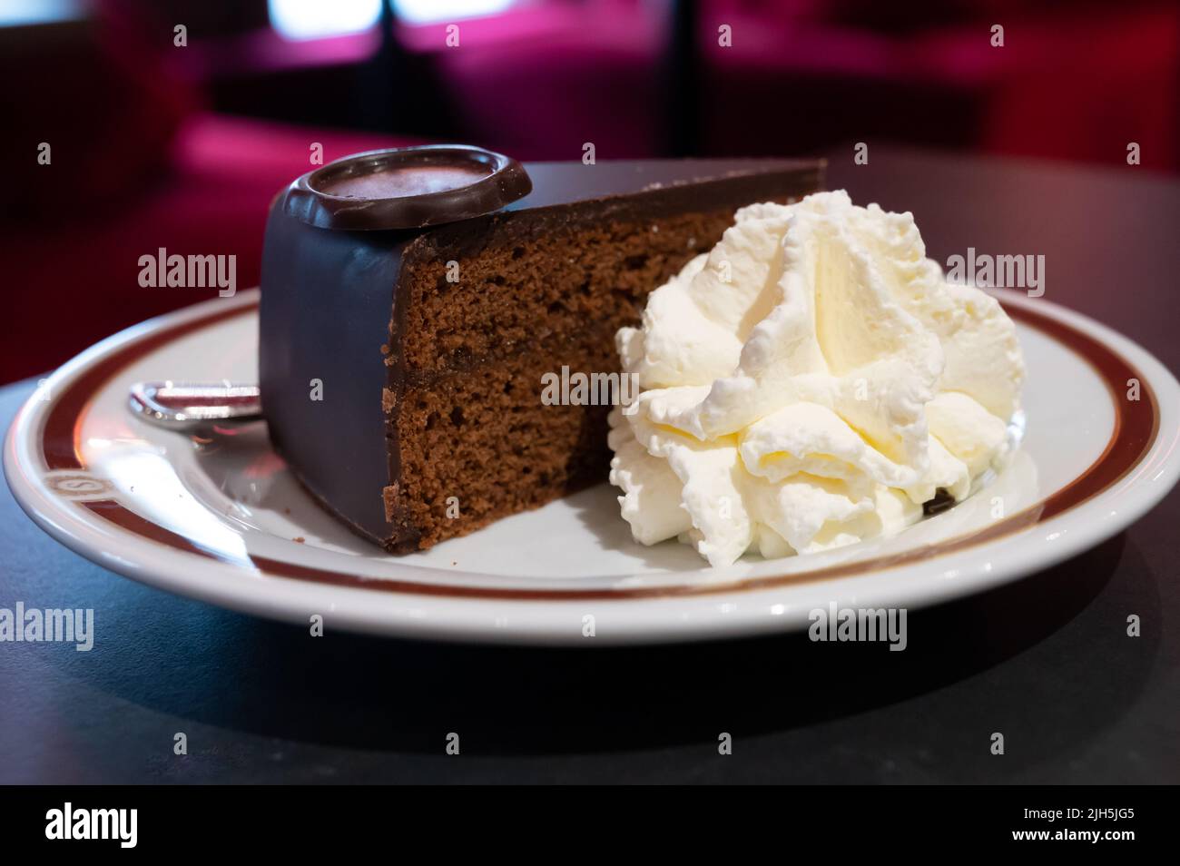 Piece of famous Sachertorte chocolate cake with apricot jam of Austrian ...