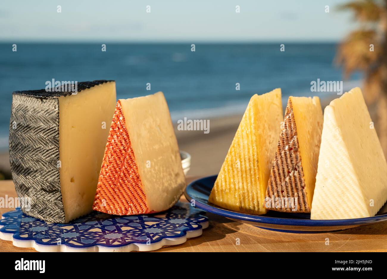 Assortment of Spanish hard cheeses, curado, manchego, goat cheese ...