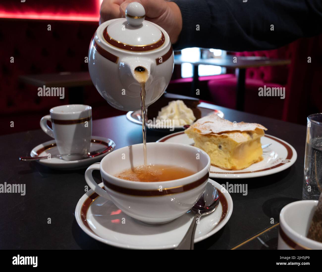 Tea time in England, pouring of black earl grey tea with bergamot in ...
