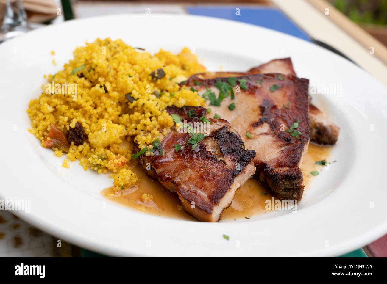 Andalusian cuisine, spicy cous-cous with grilled pork ham filet ...