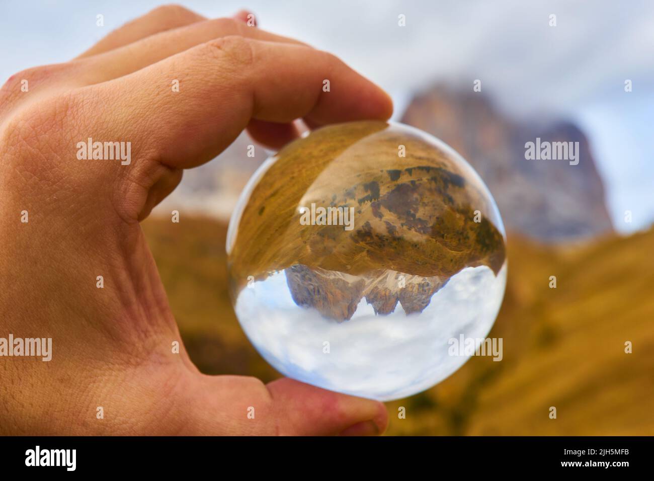 Alpine mountain view through crystal glass globe. Dolomites Alps, Italy ...