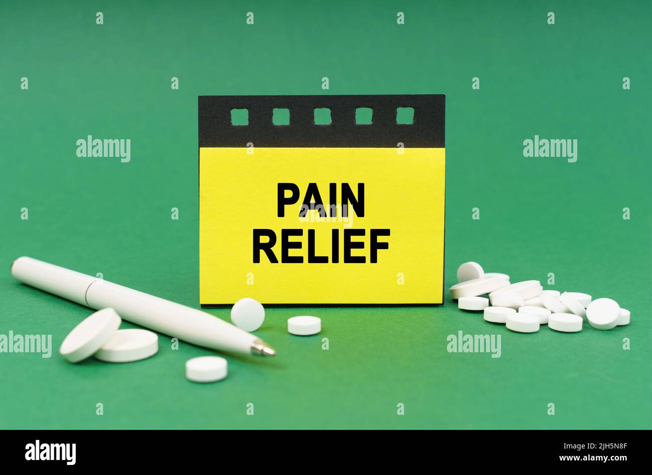 Medical concept. On the green surface are tablets, a pen and stickers ...